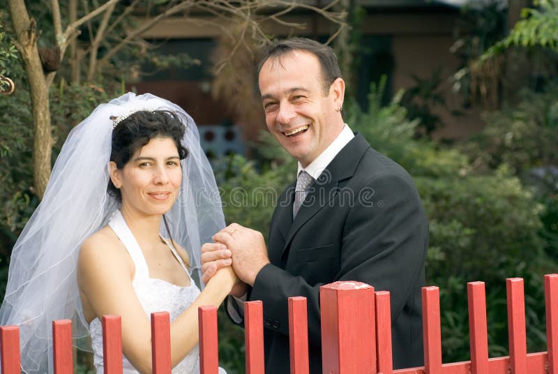 Married Couple Holding Hands Smiling - Horizontal Picture. Image: 5579931