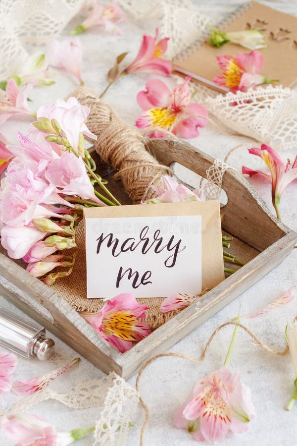 MARRY ME Card on a White Table between Pink Flowers Stock Image - Image ...
