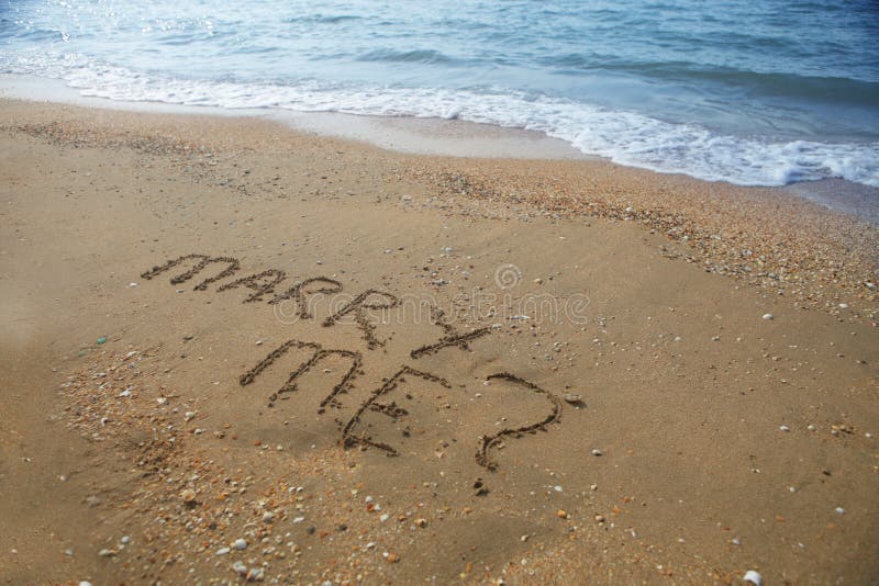 Marry Me Written on Sandy Beach Stock Photo - Image of question, people ...