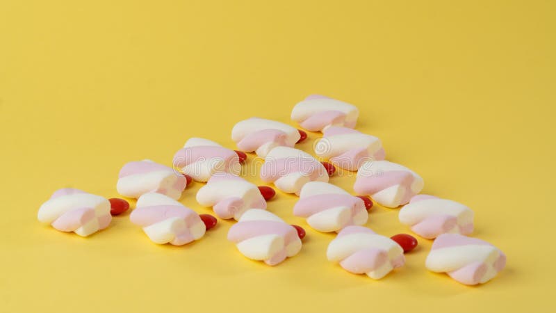Marshmallows and Red Candy Dragees in the Form of a Triangle on a ...