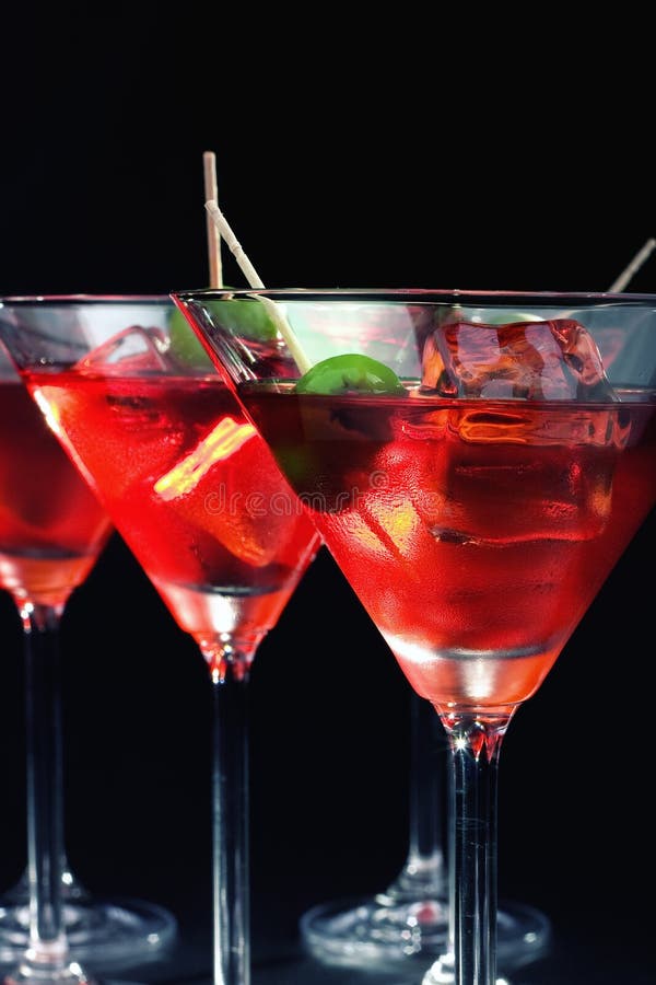 Martini Glass with Olive and Ice Cube Stock Image - Image of elegant ...