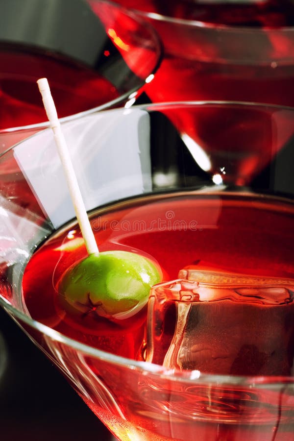 Martini Glass with Olive and Ice Cube Stock Photo - Image of party ...