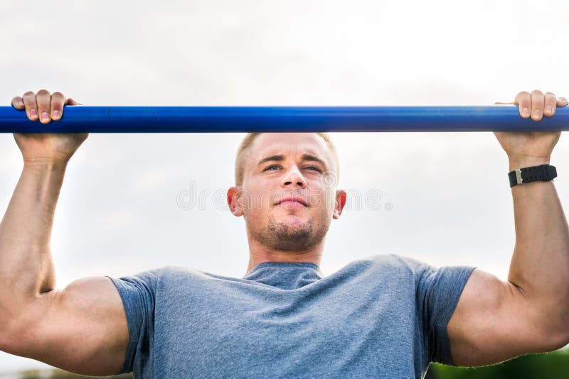 Man Doing Pull Ups Outdoors Stock Image - Image of handsome, male ...
