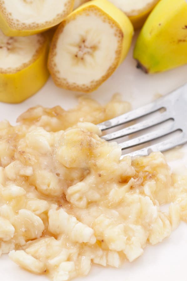Mashed Banana with Fork and an Unpeeled Fruit Stock Photo - Image of ...