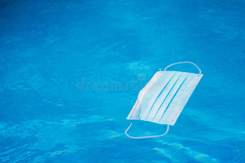 Mask Floating on Pool Water during Covid Pandemic. Stock Image - Image ...