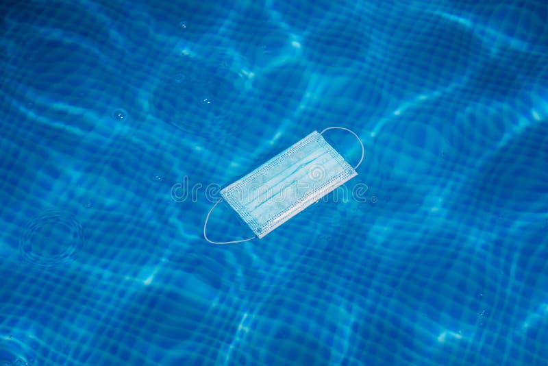 Mask Floating on Pool Water during Covid Pandemic. Stock Image - Image ...