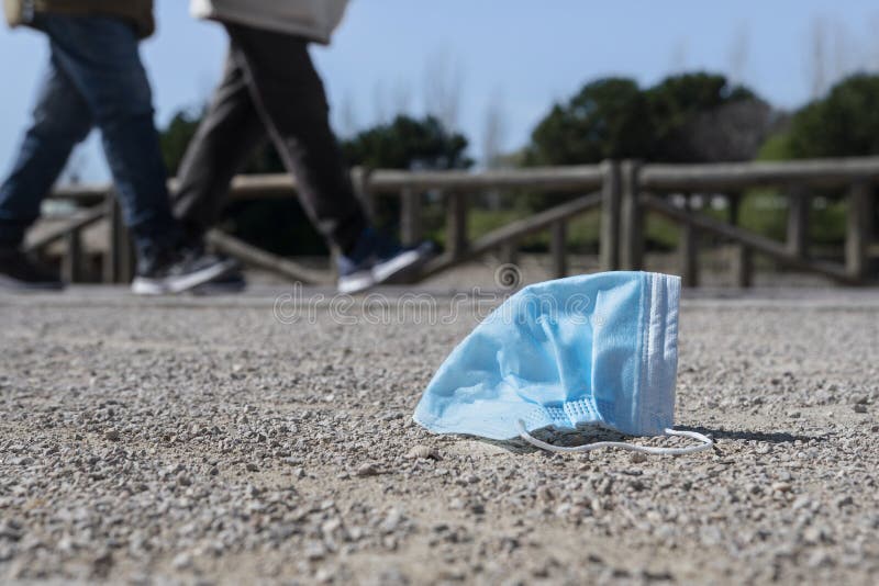 Mask on the Ground and People Walking Stock Photo - Image of macro ...