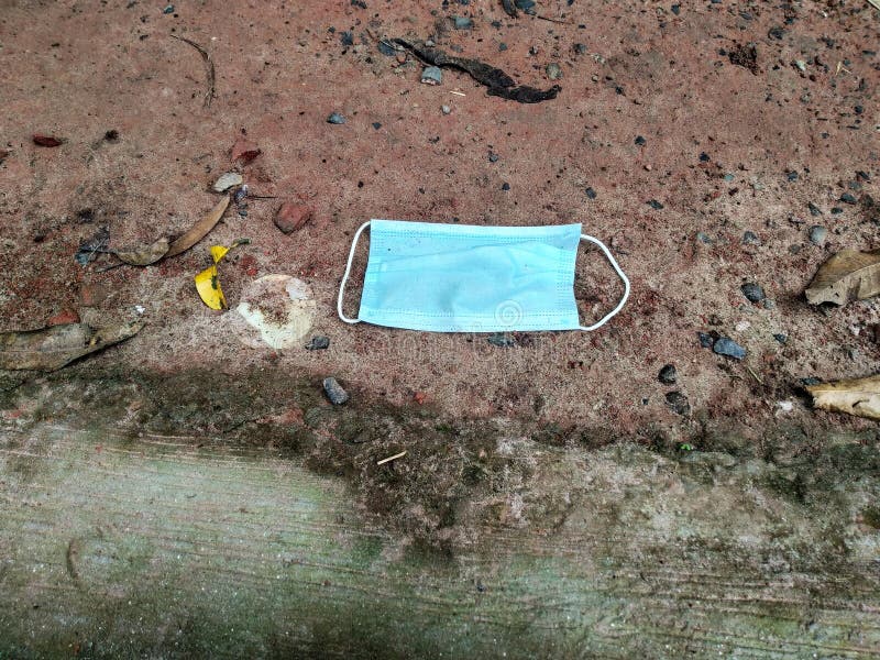 A Mask is Left on the Ground. Stock Image - Image of soil, flower ...