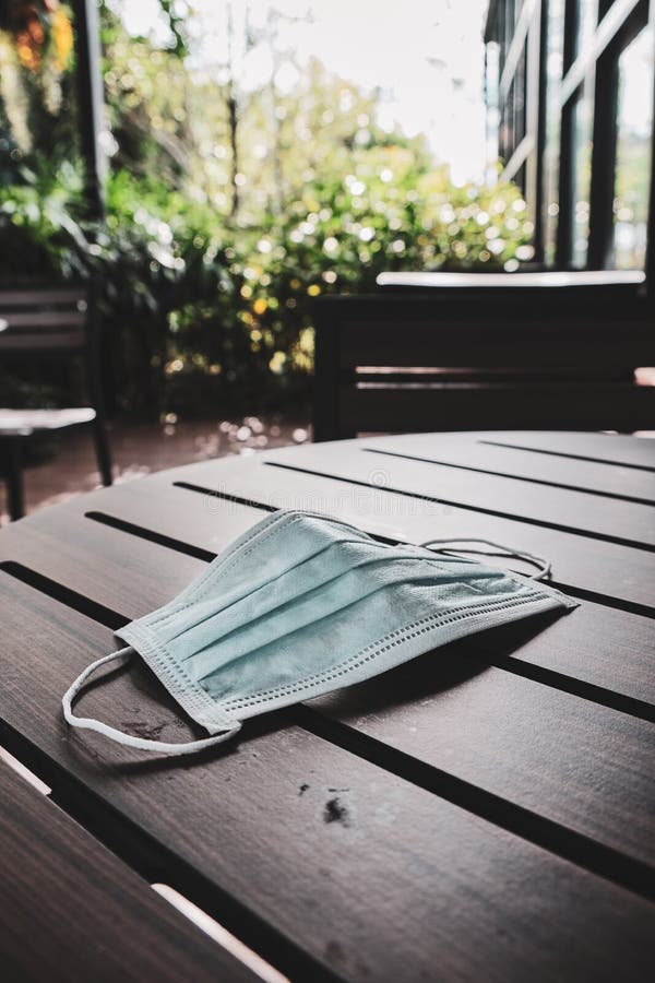 Mask on Table in Coffee Shop Stock Image - Image of distance, epidemic ...