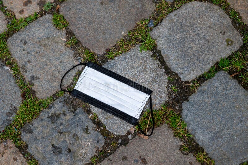 Mask thrown on a driveway stock image. Image of pandemic - 232463571