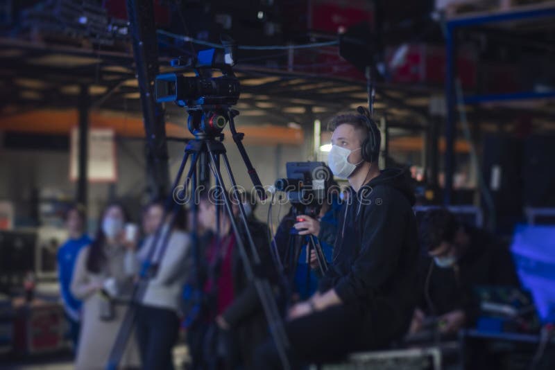 Masked Cameraman is Filming a Television Show in the Studio Editorial ...