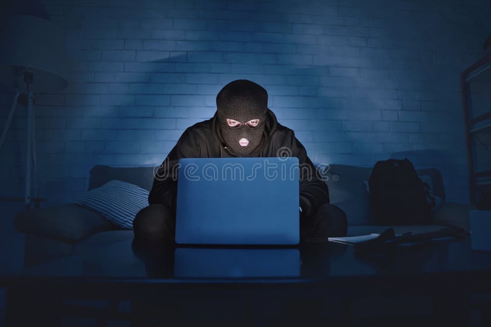 Masked Hacker Downloading Private Information Using Pc Stock Photo ...