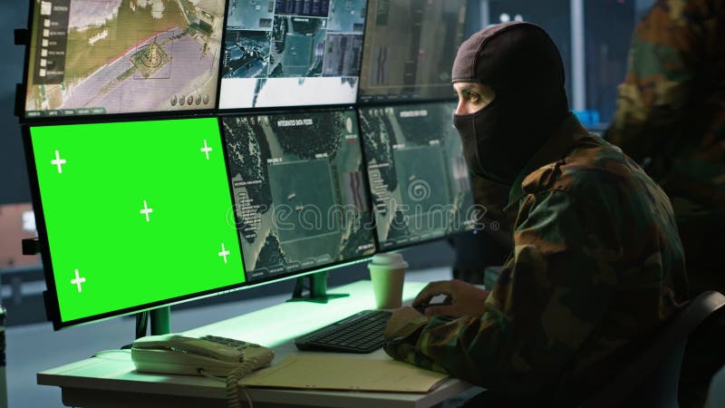 Special Forces Spy Examining Data in Monitoring Room with Chroma Key ...