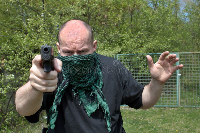 Masked man aims with gun stock photo. Image of hijacker - 39988072