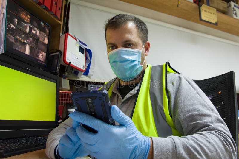 A Masked Man at a Table Works on a Computer in Office Stock Image ...