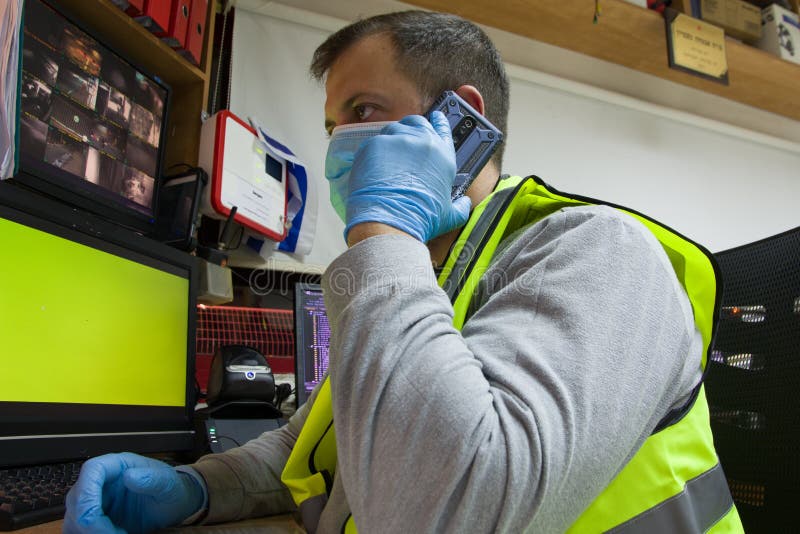 A Masked Man at a Table Works on a Computer in Office Stock Image ...