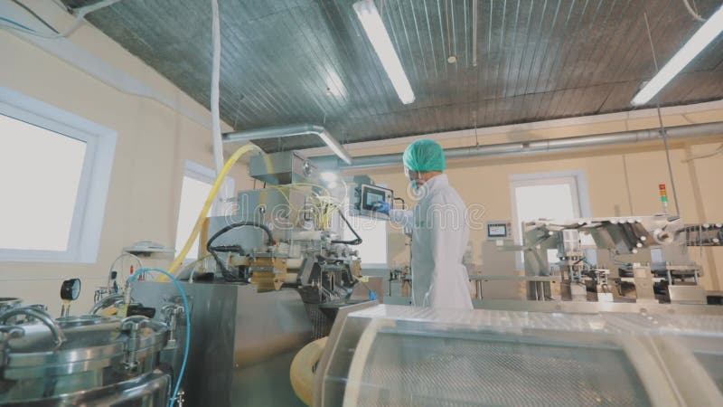Masked People Work in a Factory. Drug Manufacturing Process. Inside the ...