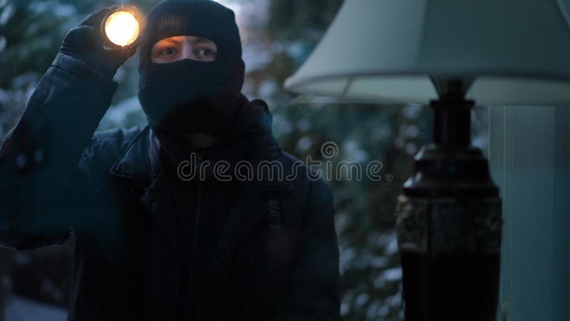 Masked Robber with Flashlight Lighting Inside Empty House Planning ...