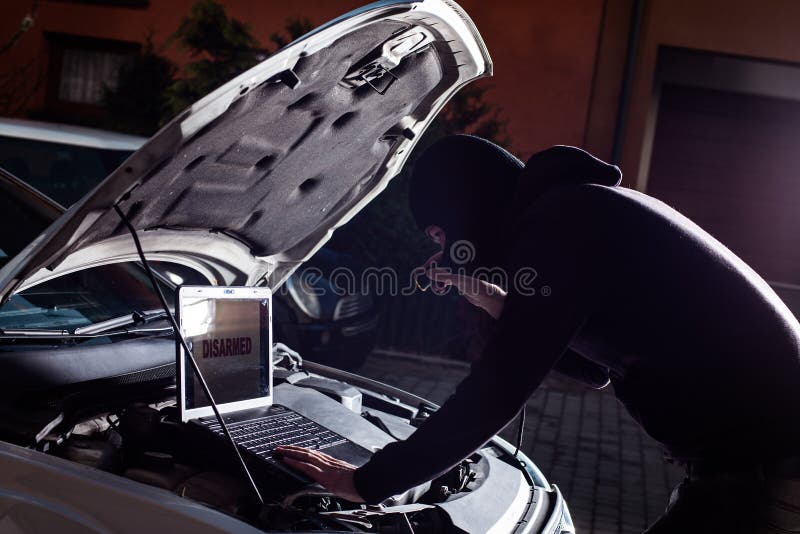 Masked Thief Hacker in a Balaclava Disarming Car Security Systems Stock ...