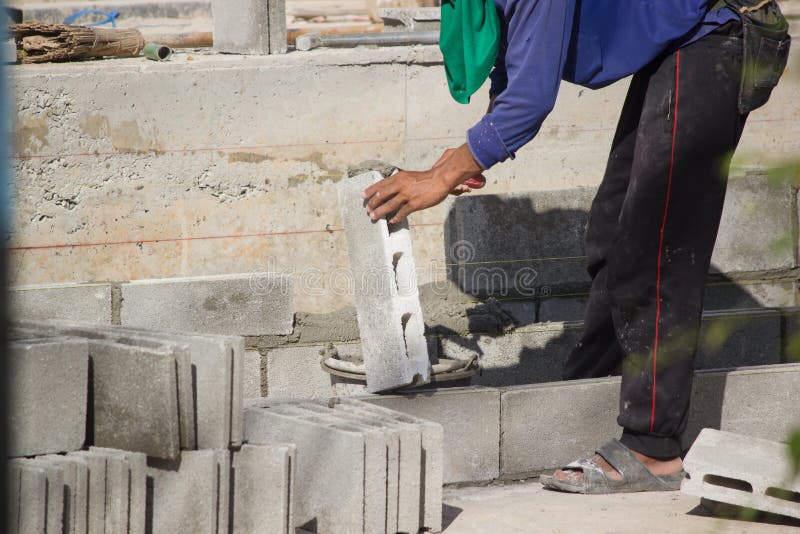 Mason or Brick Builders are Building Cement Brick Wall in Construction ...