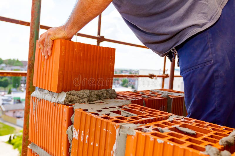 Worker is Building Wall with Red Blocks and Mortar Stock Image - Image ...