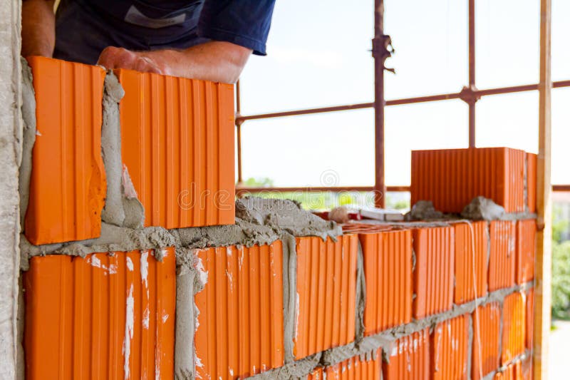 Worker is Building Wall with Red Blocks and Mortar Stock Photo - Image ...