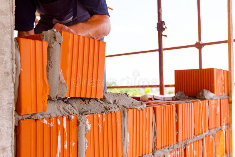 Worker is Building Wall with Red Blocks and Mortar Stock Image - Image ...