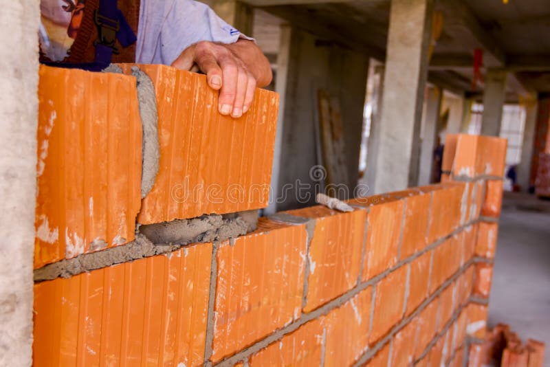 Worker is Building Wall with Red Blocks and Mortar Stock Photo - Image ...
