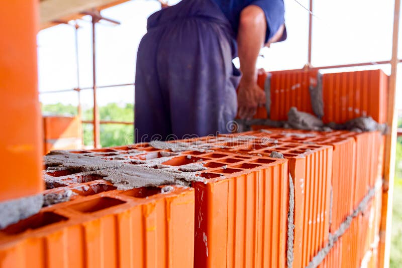 Worker is Building Wall with Red Blocks and Mortar Stock Photo - Image ...