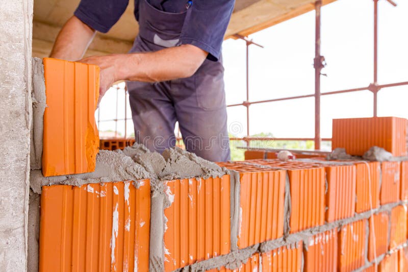 Worker is Building Wall with Red Blocks and Mortar Stock Photo - Image ...