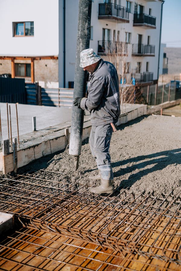 Mason Building and Worker Using a Automatic Cement Pump and Levelling a ...