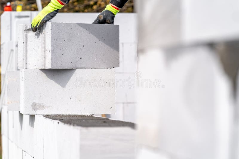 A Mason Builds the Wall of a House with Bricks Stock Photo - Image of ...