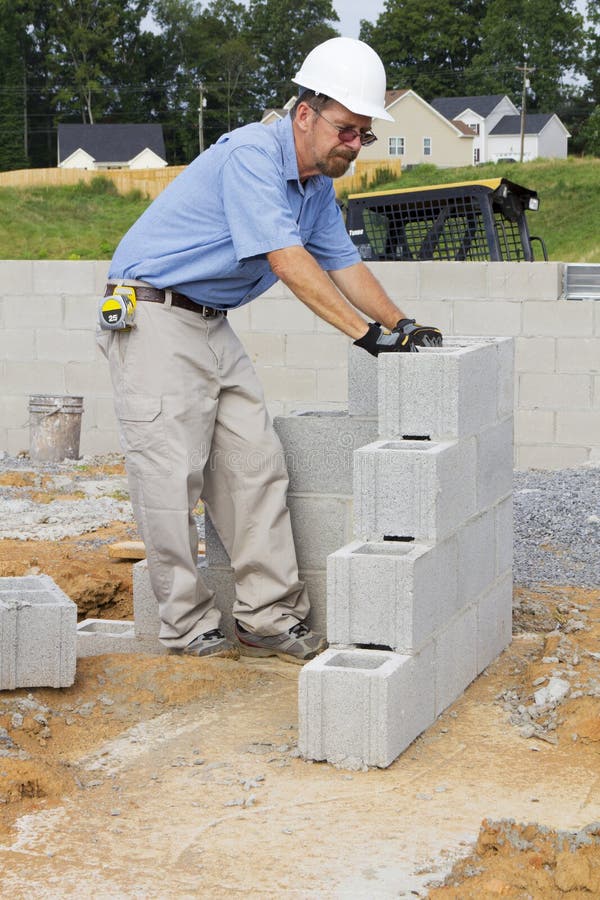 Mason with Concrete Block stock photo. Image of code - 20356626