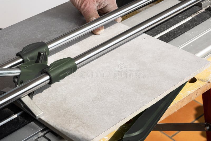 The Mason Cuts a Ceramic Tile with a Tile Cutter Stock Photo - Image of ...