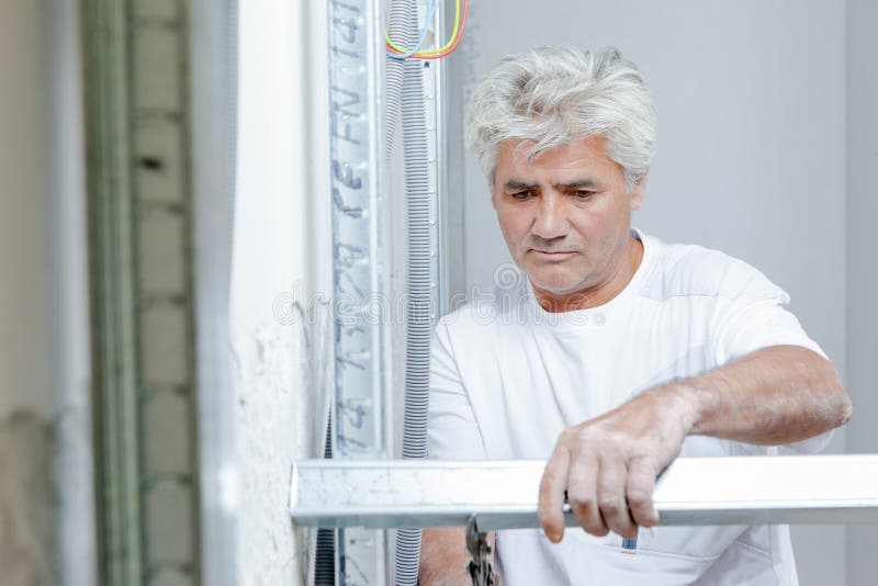 Mason Making Wall with Mortar and Bricks, Using Hammer Tool. Industrial ...