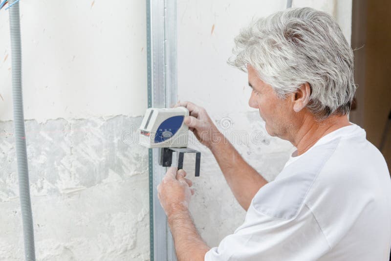 Mason measuring up wall stock image. Image of profession - 86208687