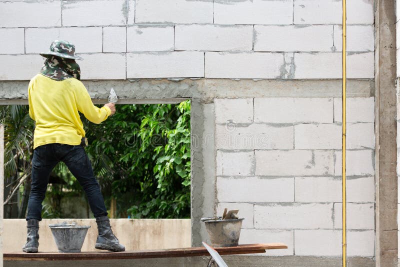 Mason Using Trowel for Plastering the Concrete To Build Wall, Co Stock ...