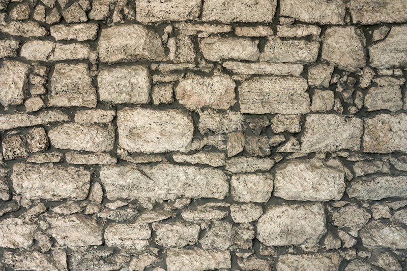 The Masonry of an Ancient Stone Wall Eroded. Close-up Stock Image ...