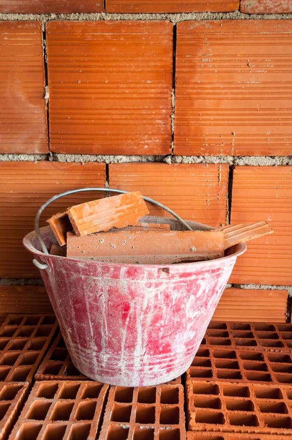 Masonry Bucket on Hollow Bricks Stock Photo - Image of home, shovel ...