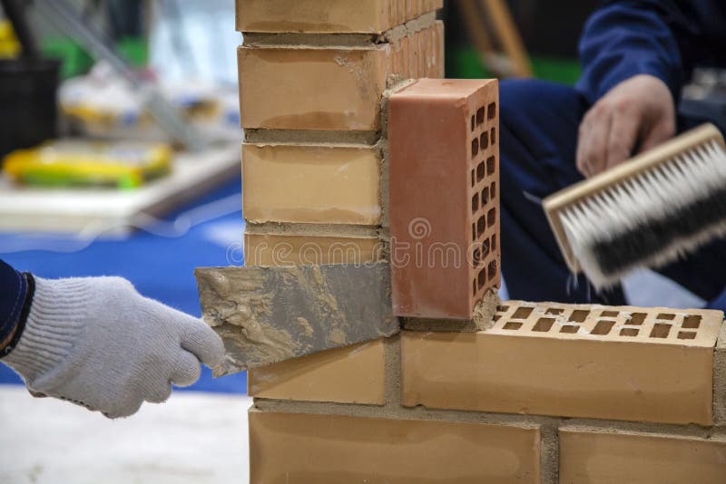 Two Workers Assemble Brick Wall, Hand-made with Cement and Brick Stock ...