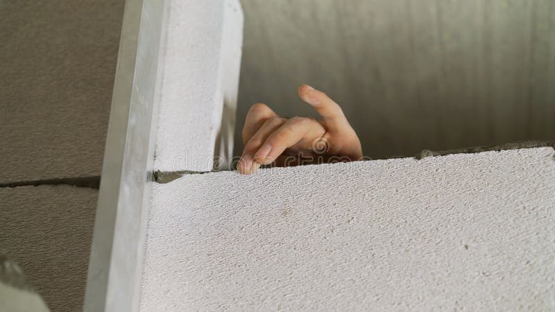 Building a Wall from Blocks. Masonry Work at a Construction Site Stock ...
