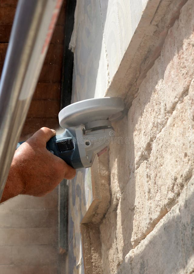 Bricklayer Cutting an Old Solid Brick Wall with Electric Radial Cutter ...
