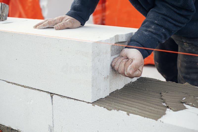 Masonry. Worker Laying Autoclaved Aerated Concrete Blocks. Builder ...