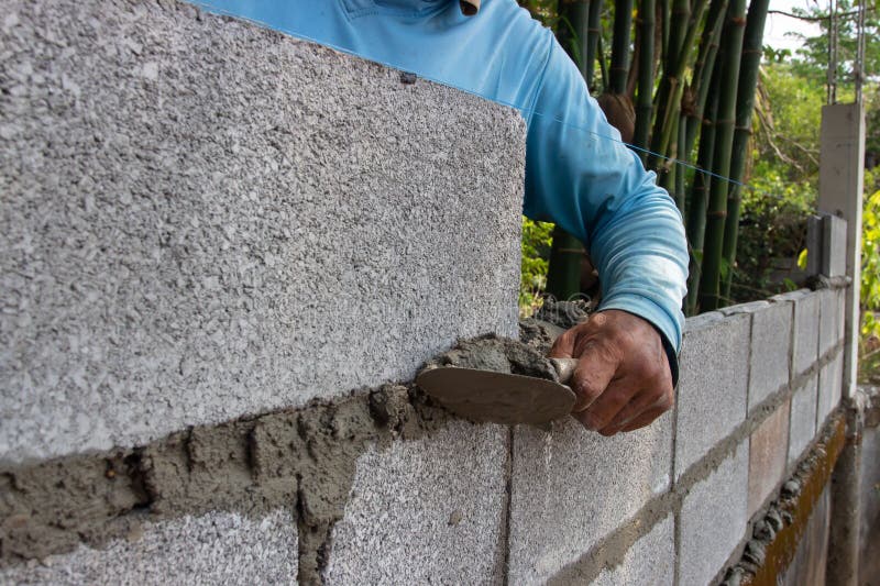 Masonry Worker Make Concrete Wall by Cement Block. Stock Photo - Image ...