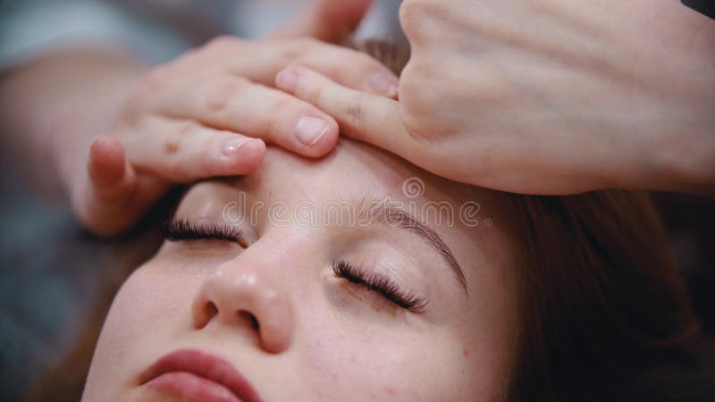 Massage - Massage Master Massaging Womans Forehead with Special ...