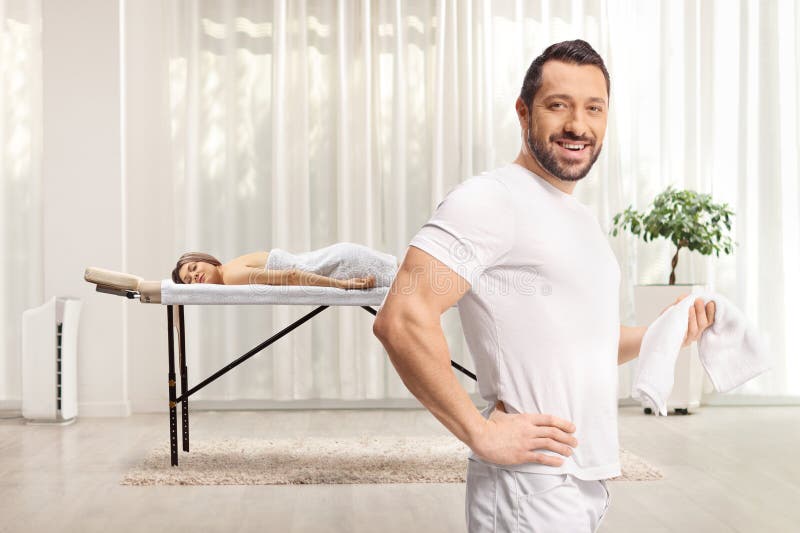 Massage Therapist with a Client Laying on a Table Stock Photo - Image ...