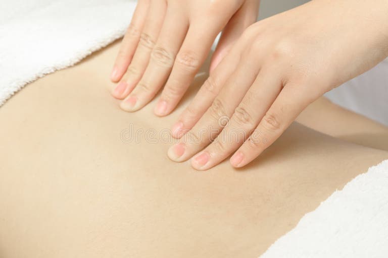 Masseur Applying Massage Techniques To Relax Back Muscles in Stock ...