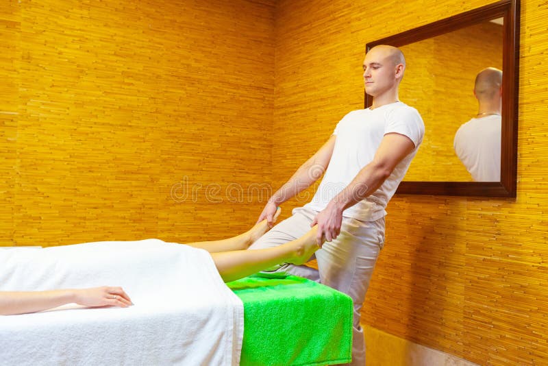 Side View Shot On Masseur Pulls Woman Arms Doing Traditional Thai