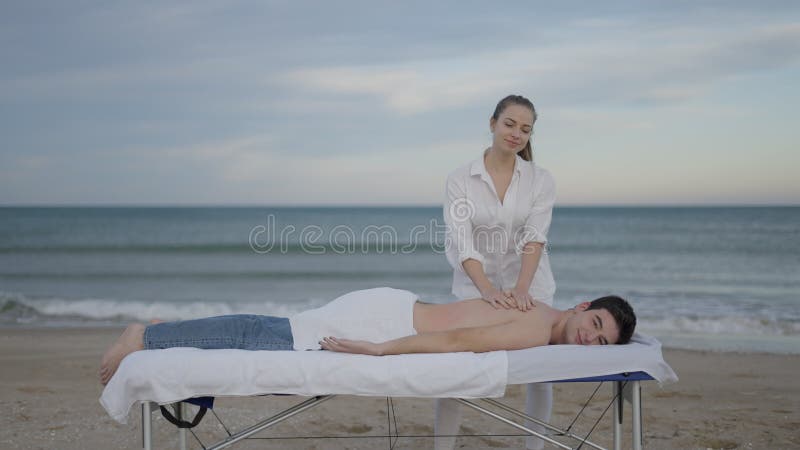 The Masseuse and His Client Stand Still and Smile for the Camera in ...