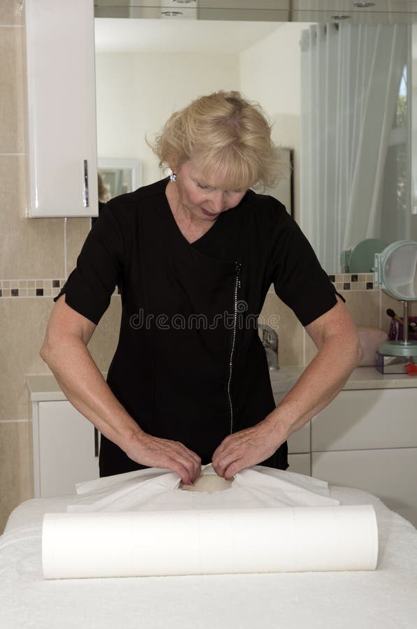 Masseuse Preparing the Client Bed with a Paper Roll Stock Image - Image ...